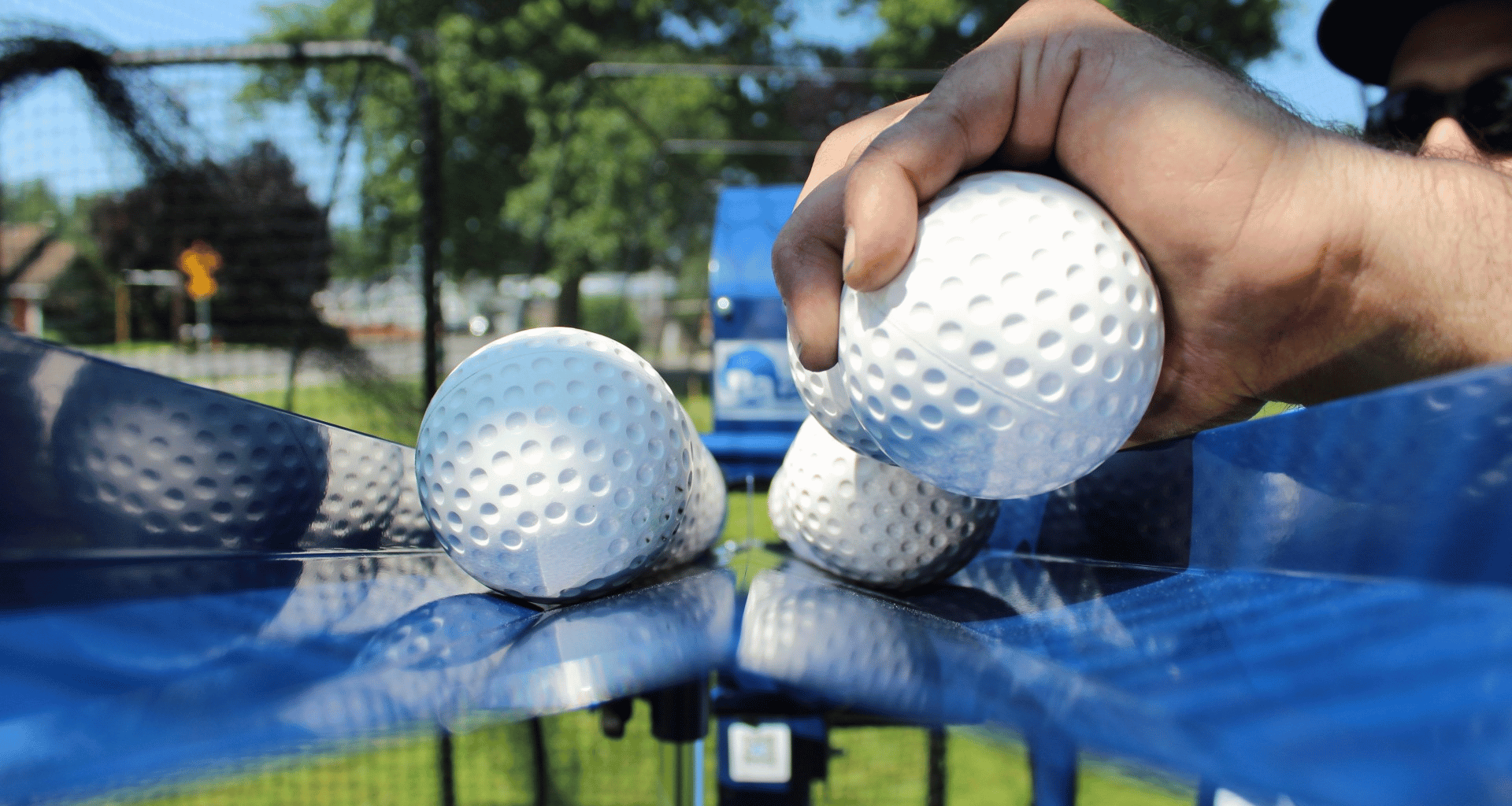 Why We Recommend Low Seam or Dimpled Baseballs For Your Pitching Machi